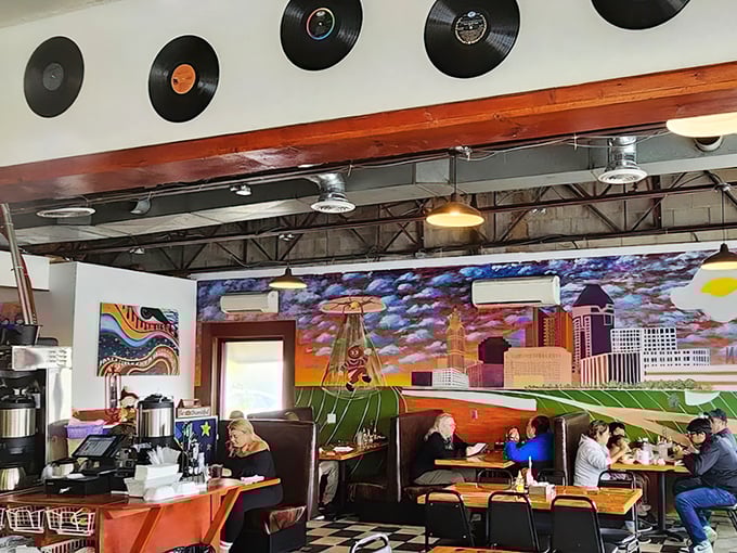 Columbus skyline art watches over diners like a colorful guardian. Those vinyl records on the wall aren't just decoration—they're the soundtrack to countless meals.