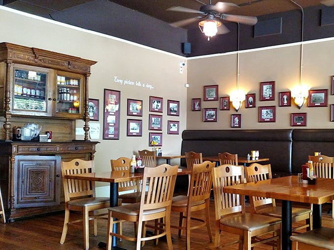 Vintage cabinets, wooden chairs, and walls adorned with framed memories—this isn't interior design, it's a community scrapbook you can dine in.