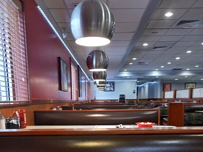 Modern pendant lighting meets classic diner booths—proof that comfort food never goes out of style, it just gets better lighting.