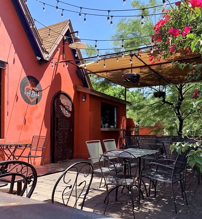 Dining al fresco under string lights with bougainvillea providing a splash of color—this patio practically demands you order another margarita.