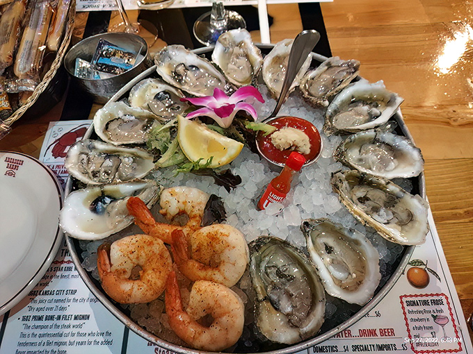 This isn't just a platter of oysters—it's Neptune's jewelry box displayed on ice. The pink orchid isn't just garnish—it's a reminder that seafood this fresh deserves a little glamour.