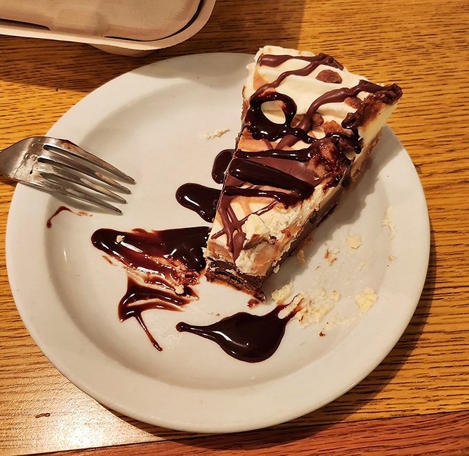 This isn't just dessert—it's therapy on a plate. Peanut butter fudge pie with chocolate drizzle that makes you wonder why you ever waste calories on lesser sweets