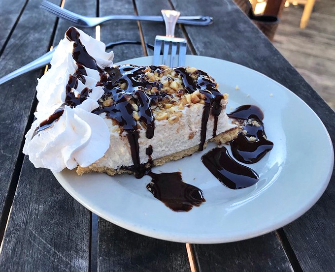 Not just any dessert – a slice of heaven with whipped cream and chocolate drizzle. The perfect sweet finale to a seafood symphony.