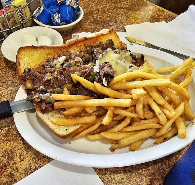 This Philly cheesesteak doesn't need Philadelphia's approval—it's confident in its melty, meaty magnificence alongside fries that deserve their own fan club.