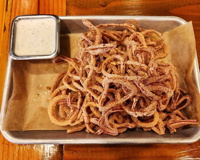 These aren't just onion strings—they're crispy, tangled evidence that vegetables can have more fun than the rest of the plate.
