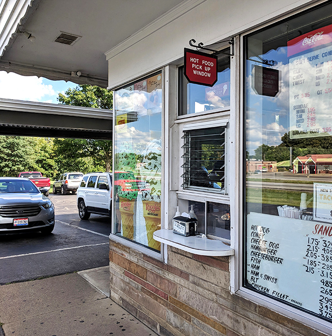 Where culinary magic happens—this pickup window has witnessed more joy than most therapists' offices.