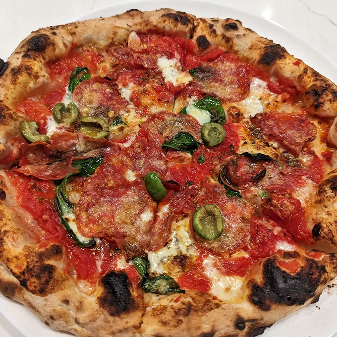 The Diavola brings just enough heat to wake up your taste buds without sending them into witness protection. Those green olives are genius.