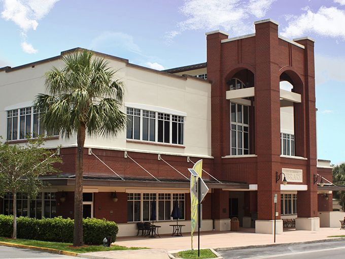 The public library blends brick solidity with Florida lightness. A temple of knowledge where air conditioning is as valued as the books inside.