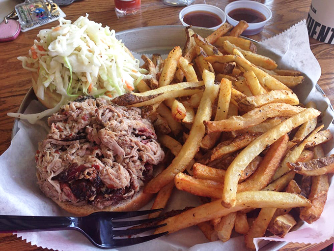 The pulled pork sandwich with fries—a masterclass in simplicity where smoke, tang, and potato perfection create the holy trinity of lunch satisfaction.