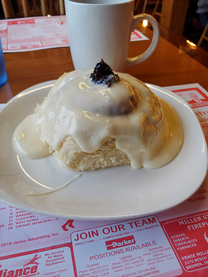 This cinnamon roll, drowning in icing, isn't just breakfast—it's therapy. No problems exist that this couldn't temporarily solve.