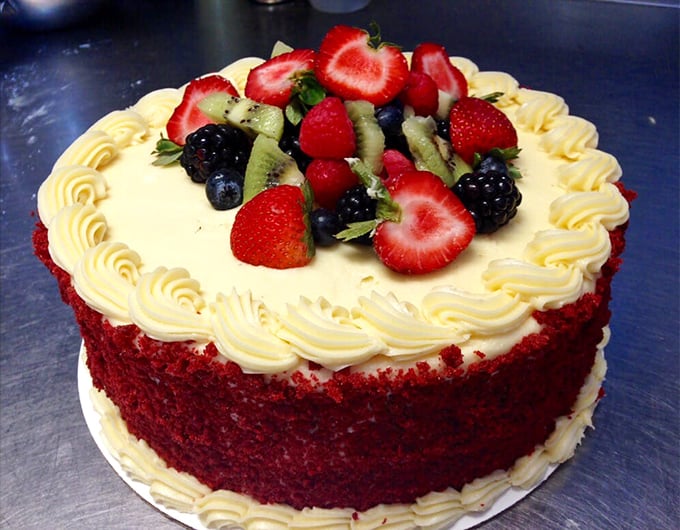 Red velvet cake crowned with fresh berries—the dessert equivalent of putting on your Sunday best for a special occasion.