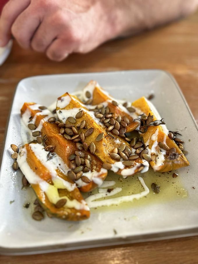 Roasted squash transformed into candy-like morsels, drizzled with creamy sauce and sprinkled with seeds. Vegetables having their glamour shot.