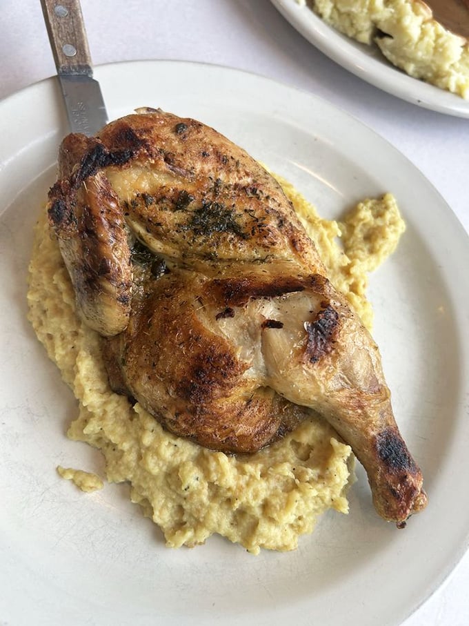 Half a roasted chicken lounging on a bed of homemade stuffing like it owns the place—because it does.