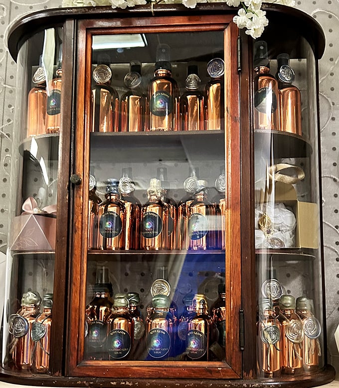 This vintage display cabinet showcases amber bottles like liquid gold behind glass—proof that even ordinary objects become treasures with the right presentation.