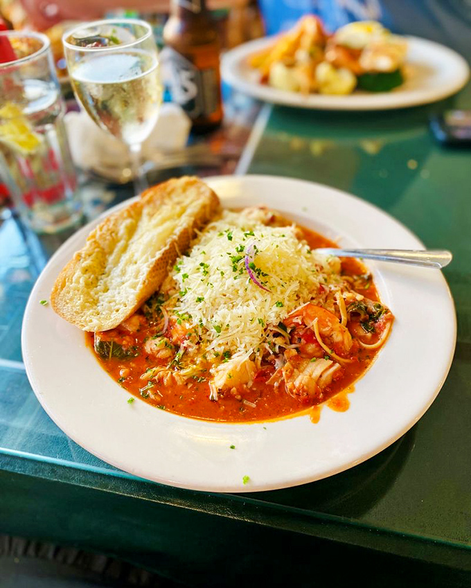 A seafood pasta that's practically a marine census, topped with enough cheese to make an Italian grandmother nod in approval.