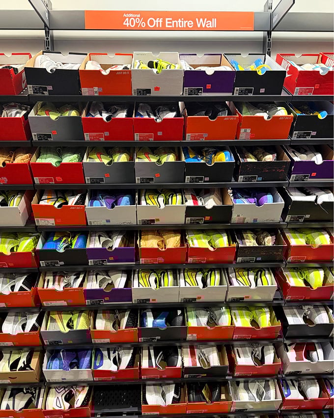 The Nike clearance wall—a magnificent monument to athletic aspirations where wallets and workout goals find happy compromise.