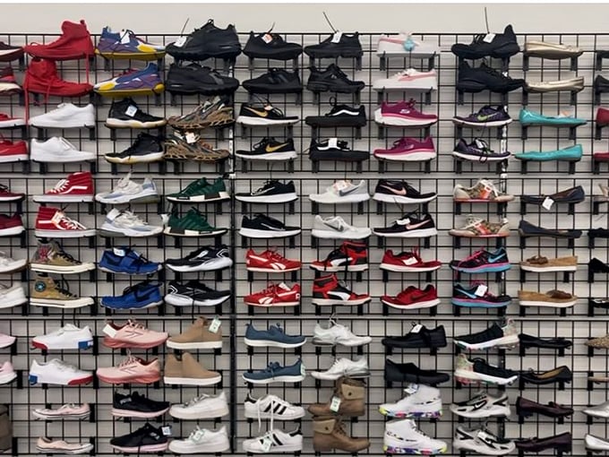 Sneaker heaven arranged with military precision—where gently worn Nikes and barely-scuffed Adidas find their second stride.