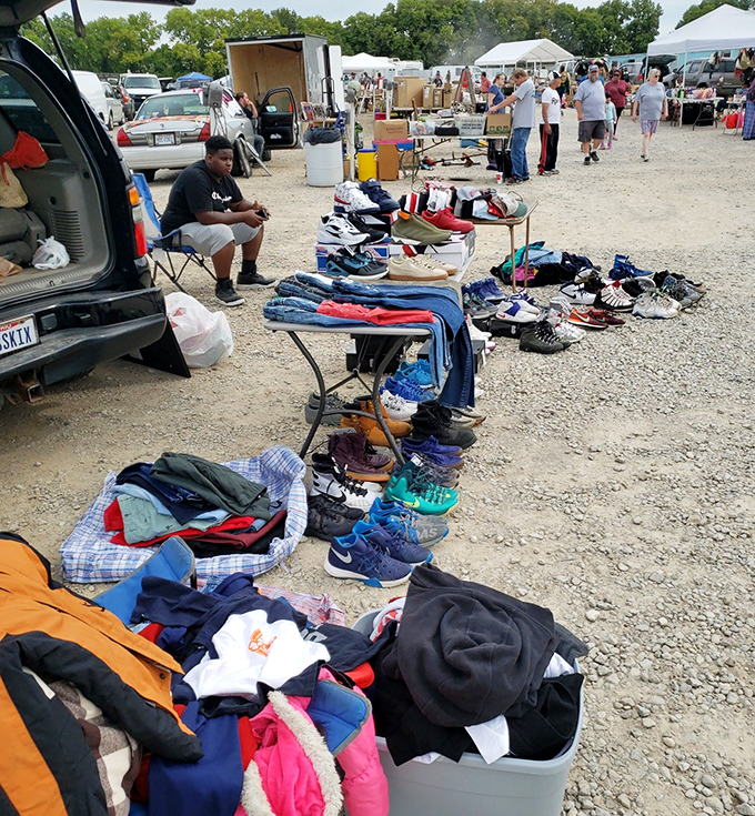 Flea market treasures spread across the gravel – yesterday's fashion finding tomorrow's admirers in cinema's shadow.