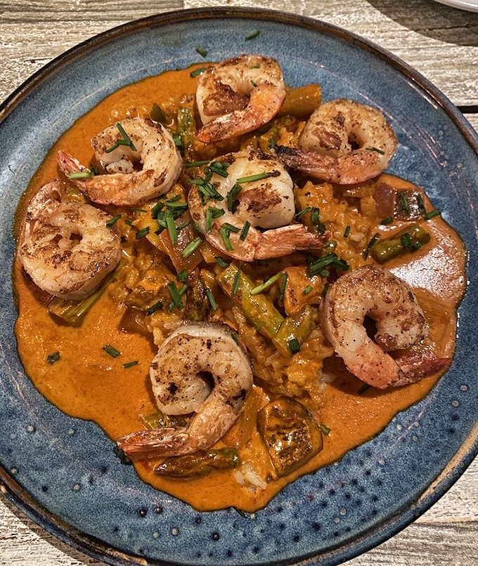 Shrimp arranged like synchronized swimmers in a curry pool so luscious you'll want to request a spoon for the sauce alone. This dish doesn't just satisfy—it transports.