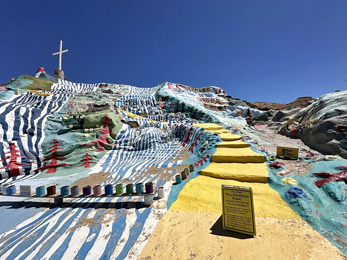 The famous "yellow brick road" invites visitors upward, its sunny path winding through waves of blue and white stripes like a desert Oz.