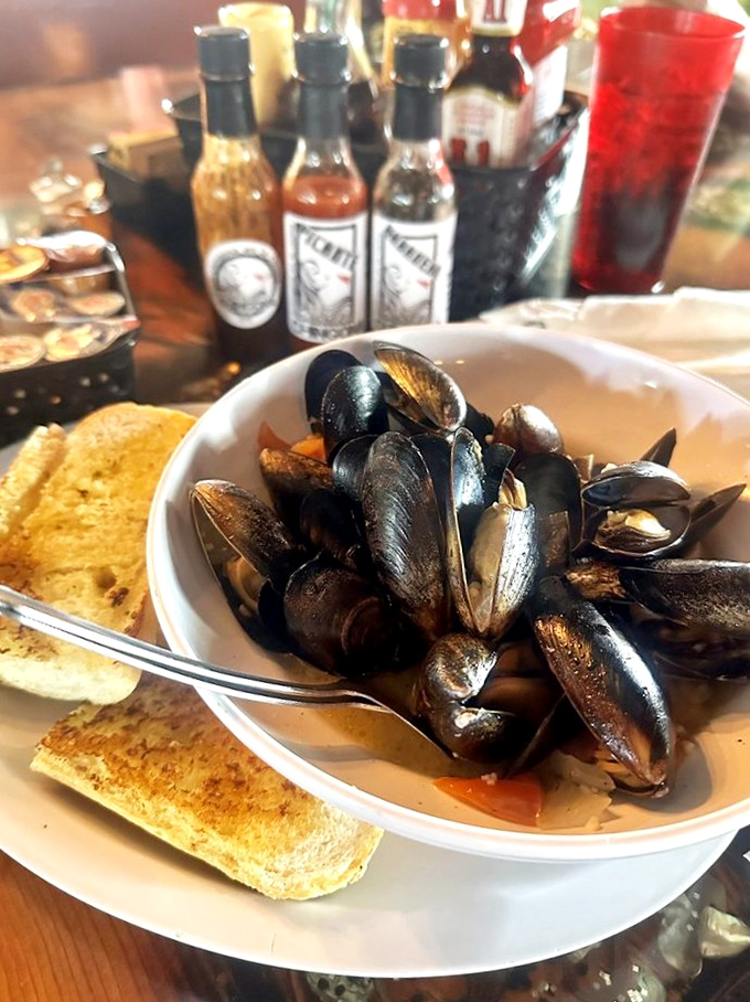 Midnight-blue mussels ready for their close-up. These plump beauties swimming in savory broth make sharing optional but not recommended.