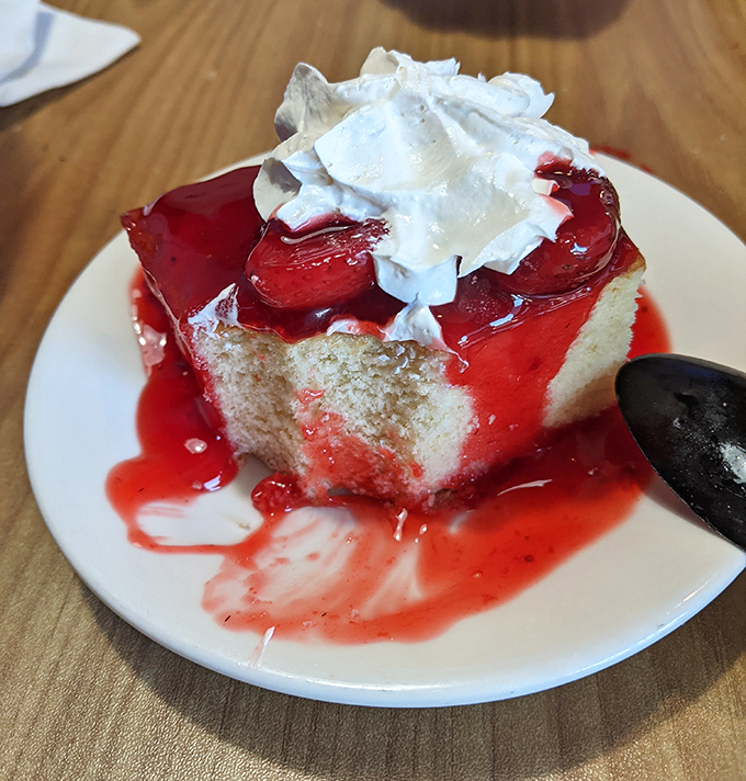 This strawberry shortcake isn't just dessert—it's edible artwork. The whipped cream crown melts into sweet berry sauce like a delicious chemistry experiment.