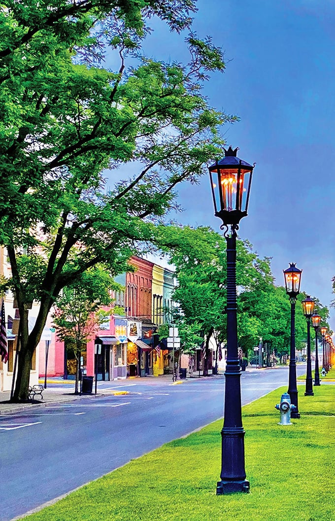 As evening descends, Wellsboro's gas lamps create a golden glow against storefronts, transforming an ordinary street into something from a holiday movie set.