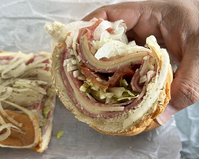 The Super Sub doesn't just satisfy hunger—it obliterates it. Layers of meat and cheese create a sandwich architecture that would impress Frank Lloyd Wright.