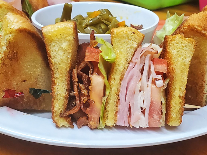 This isn't just a sandwich – it's an architectural marvel of perfectly stacked meats, vegetables, and toast that somehow maintains structural integrity until the last bite.