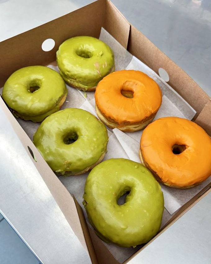 These vibrant green and orange donuts aren't having an identity crisis—they're boldly showcasing Thai tea flavors in donut form. Cultural fusion at its finest.