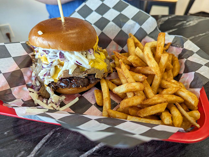 Behold the burger in its natural habitat—a study in contrasts with melty cheese cascading over a substantial patty on a perfectly toasted bun. 