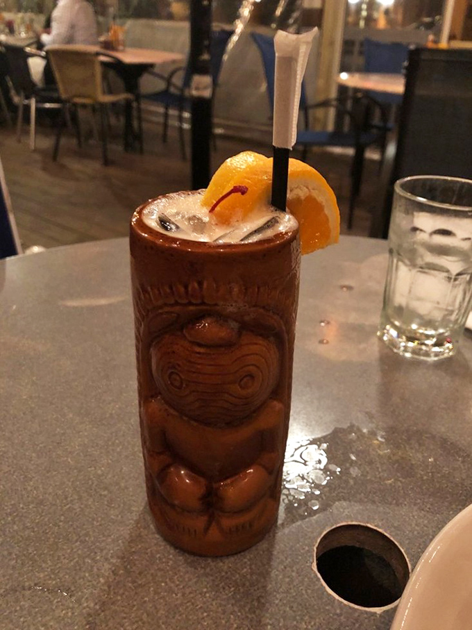 A tiki drink that's wearing more accessories than a Palm Springs retiree. That orange slice isn't decoration—it's a vitamin C delivery system.