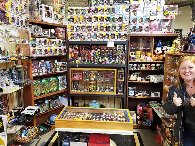Funko Pop figures stand at attention alongside vintage toys. The collector's gleeful thumbs-up says it all—another successful treasure hunt completed!