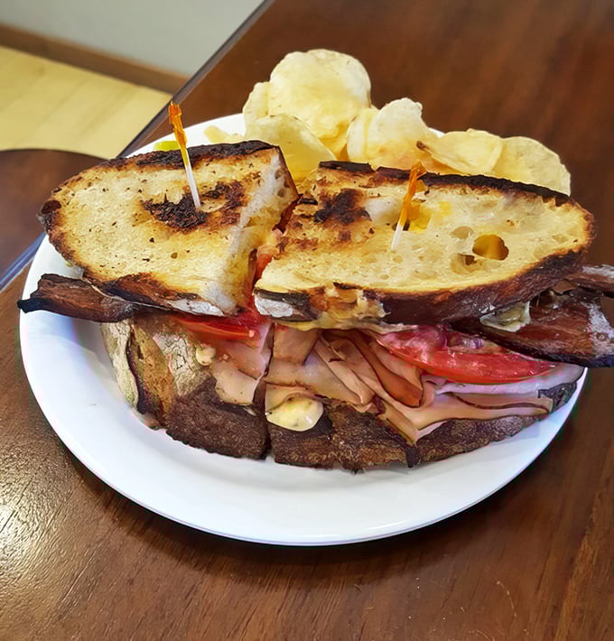 A proper sandwich requires proper construction—note the strategic layering that ensures every bite delivers the perfect ratio of ingredients.