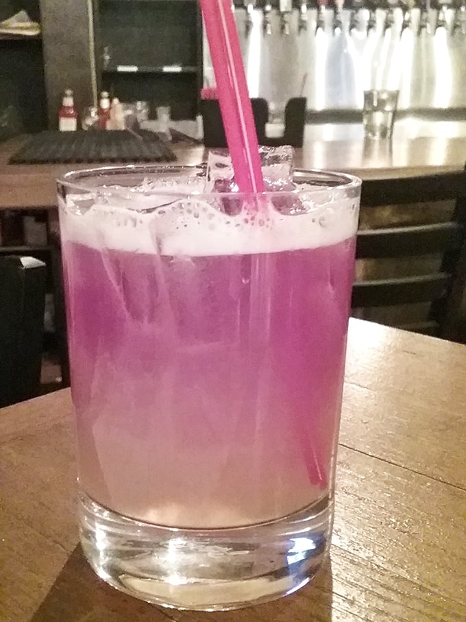 This vibrant purple cocktail isn't just a drink – it's a conversation starter. Like a sunset in a glass, it promises refreshment with a side of intrigue.