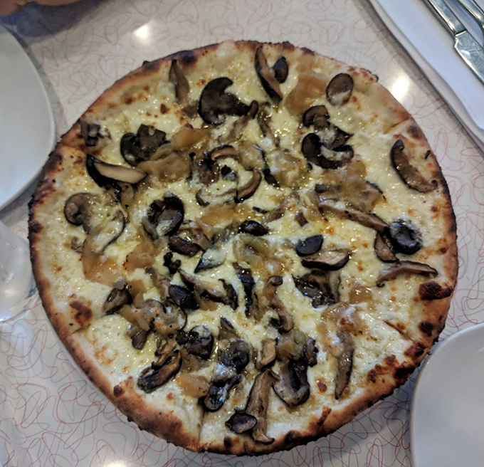 The Wild Mushroom White Pizza showcases fungi in their finest hour—earthy, aromatic, and unapologetically delicious.