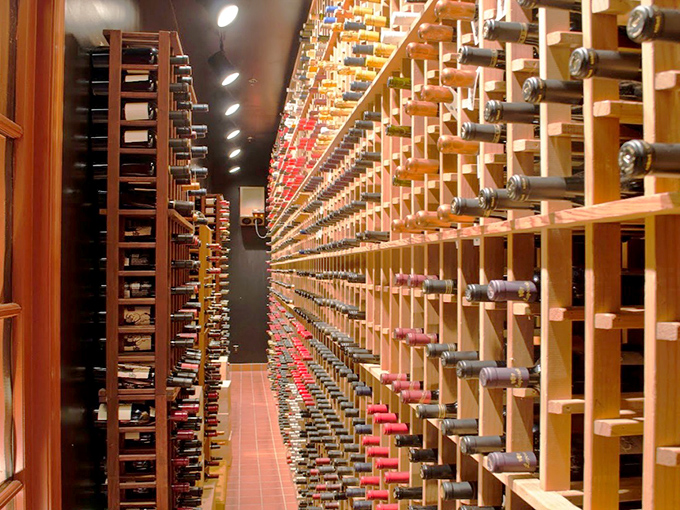 Not just a wine cellar—a cathedral of cabernet where bottles wait patiently for their moment to shine alongside a perfect cut.