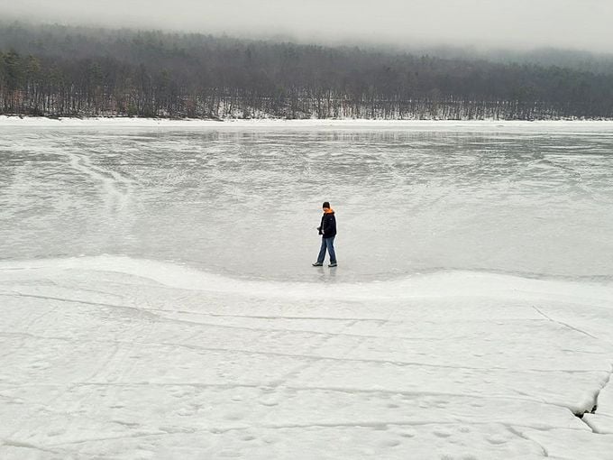 Winter transforms the reservoir into a vast frozen playground where brave souls venture onto nature's temporary floor – no waxing required.