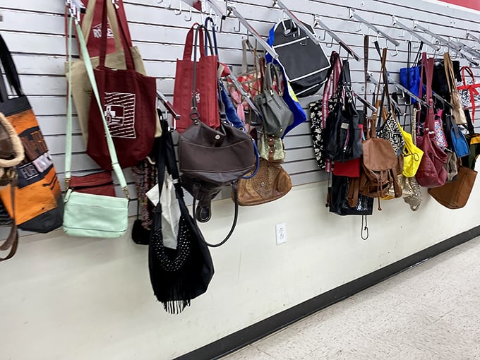 A wall of handbags dangles like colorful fruit, each with previous lives and stories waiting for new chapters.