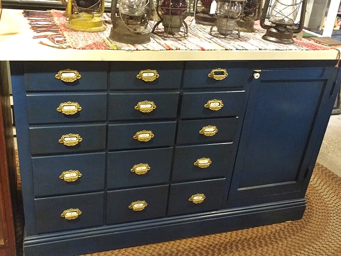 Navy blue with brass hardware—this apothecary-style cabinet could organize everything from craft supplies to cocktail ingredients with vintage panache.