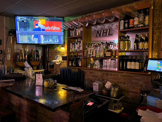 The bar at Pequod's—where strangers become friends over shared pizza opinions and the bartenders know exactly when you need another round.