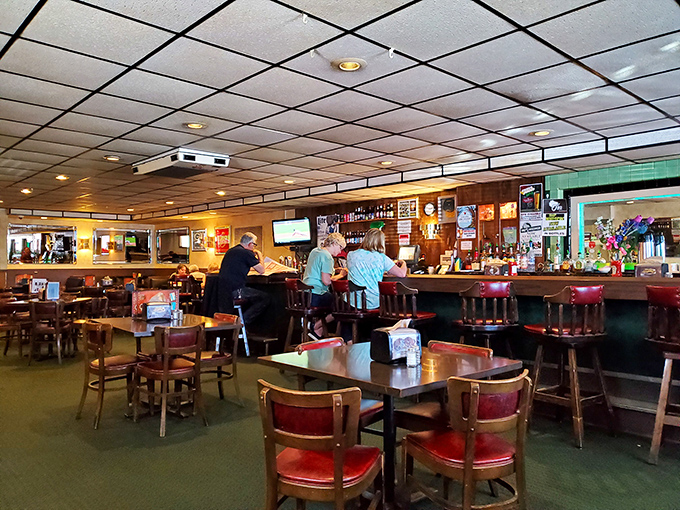 The bar area—where strangers become friends and regulars are treated like royalty, all under the glow of whatever game is playing.