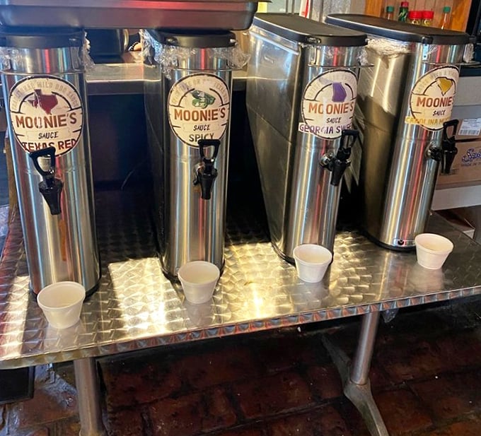 The sauce dispensers stand at attention like soldiers guarding flavor treasures. Choose your weapon wisely—each brings its own personality to the party.