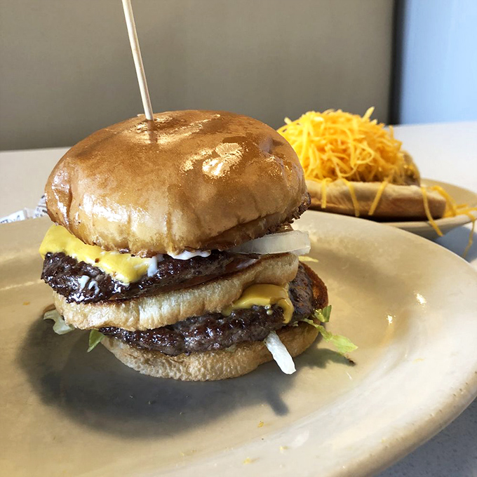 This double-decker burger doesn't just satisfy hunger—it obliterates it, with a side of cheese-covered chili dogs for those still standing.