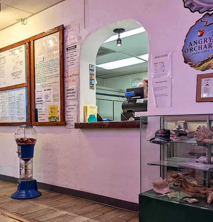 The ordering counter—where seafood dreams begin. That gumball machine isn't filled with ocean water, but the seafood is as fresh as if it were.