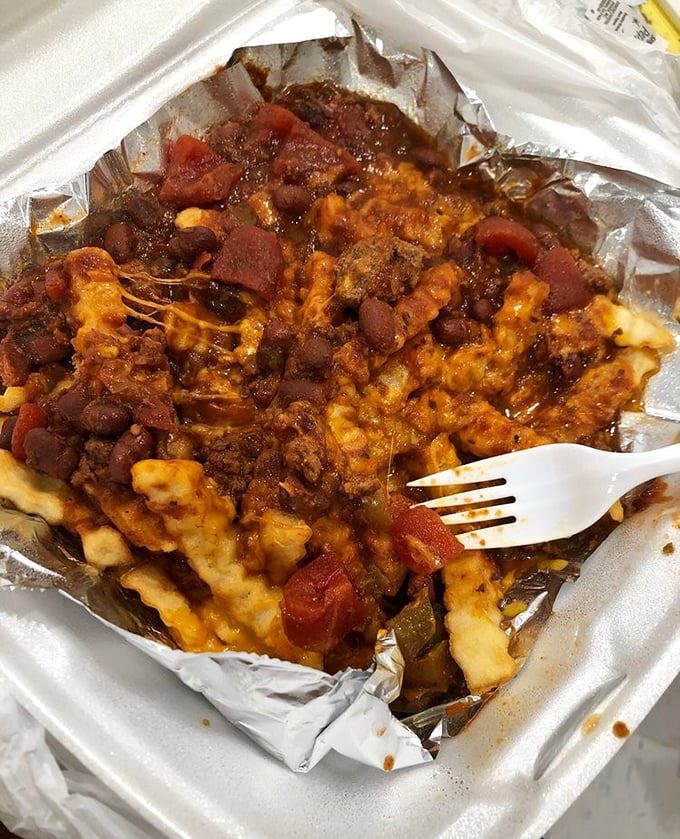 Chili cheese fries that laugh in the face of utensils. A glorious mess that's worth every napkin and the occasional shirt casualty.