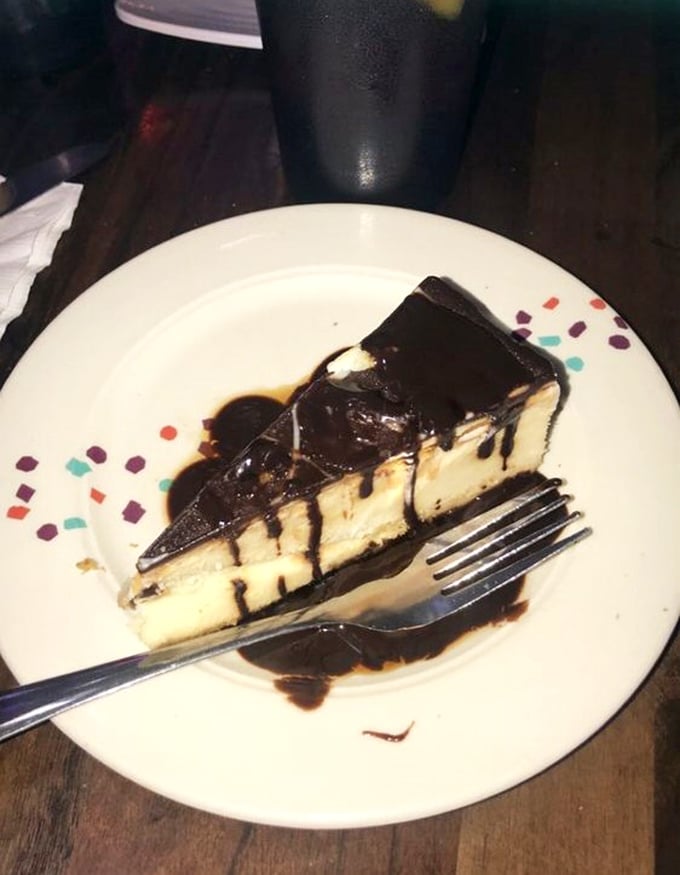 A chocolate cheesecake that doesn't just satisfy your sweet tooth—it makes it write thank-you notes. That chocolate drizzle is pure edible artistry.