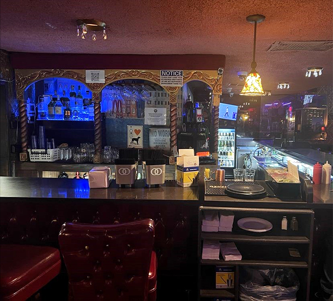 The bar area glows with that perfect amber light that makes everyone look like they've stepped out of a classic film noir.