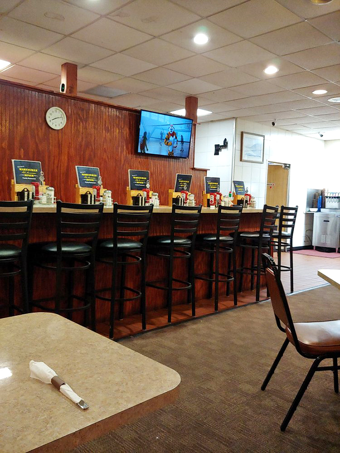 The counter seating—complete with swivel stools and wood paneling—offers front-row tickets to the short-order ballet performed daily by seasoned cooks.