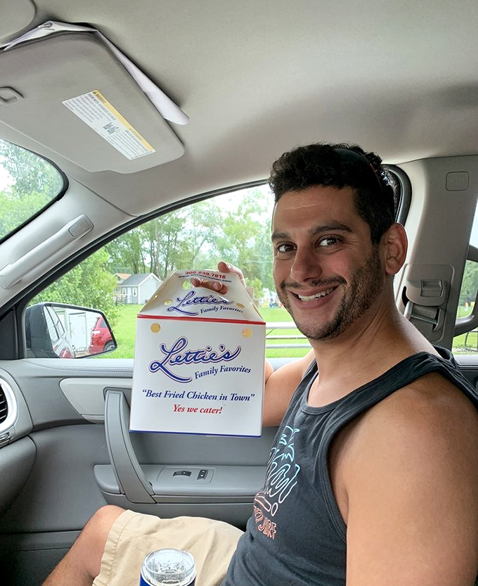The universal expression of takeout triumph. That box contains what locals know is Delaware's edible treasure—fried chicken worth the drive from anywhere.